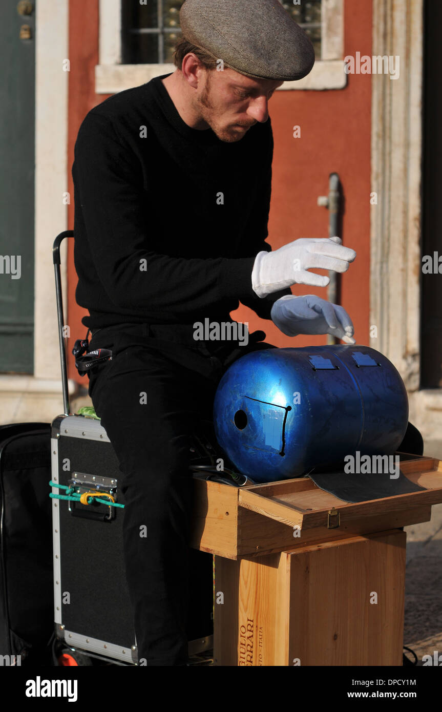 A man playing a gas bottle hang drum, a musical instrument made from a ...