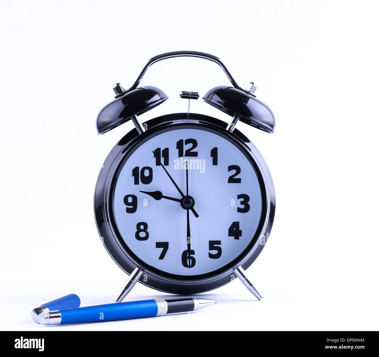 Alram clock on white background with pen closeup Stock Photo - Alamy