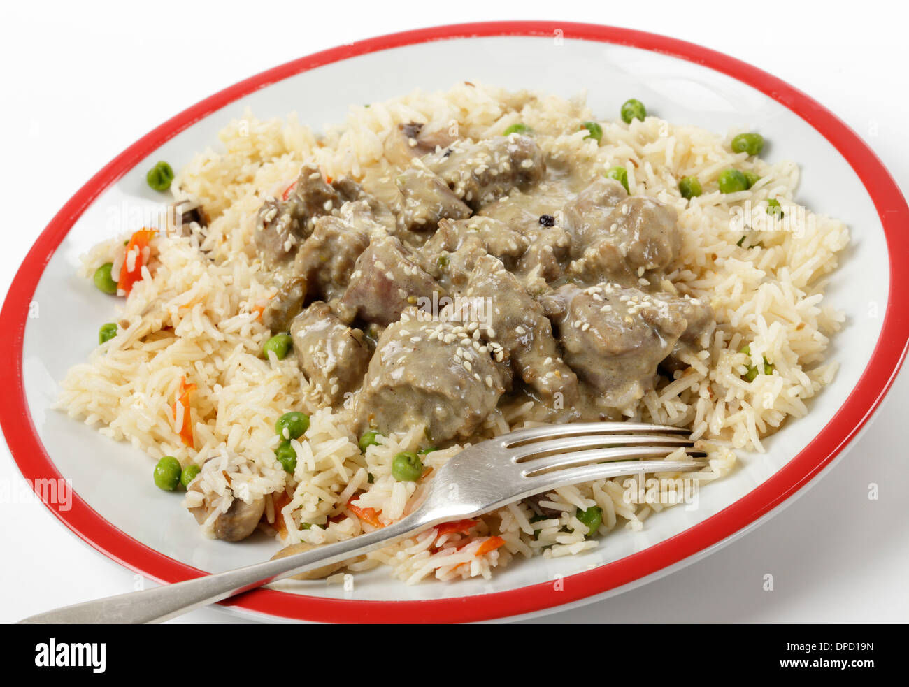 Creamy lamb korma curry garnished with toasted sesame seeds and served ...