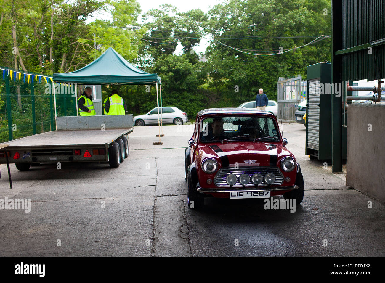 A classic racing red Mini Cooper 1275 GT car at a rural country fair ...
