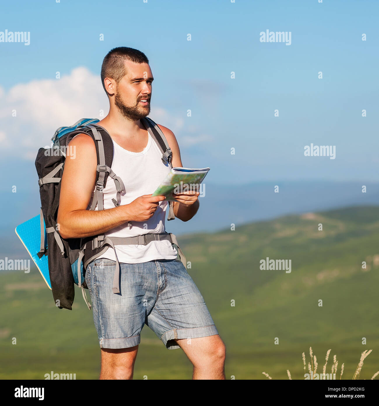 Hiker with backpack standing on top of a mountain with map Stock Photo ...