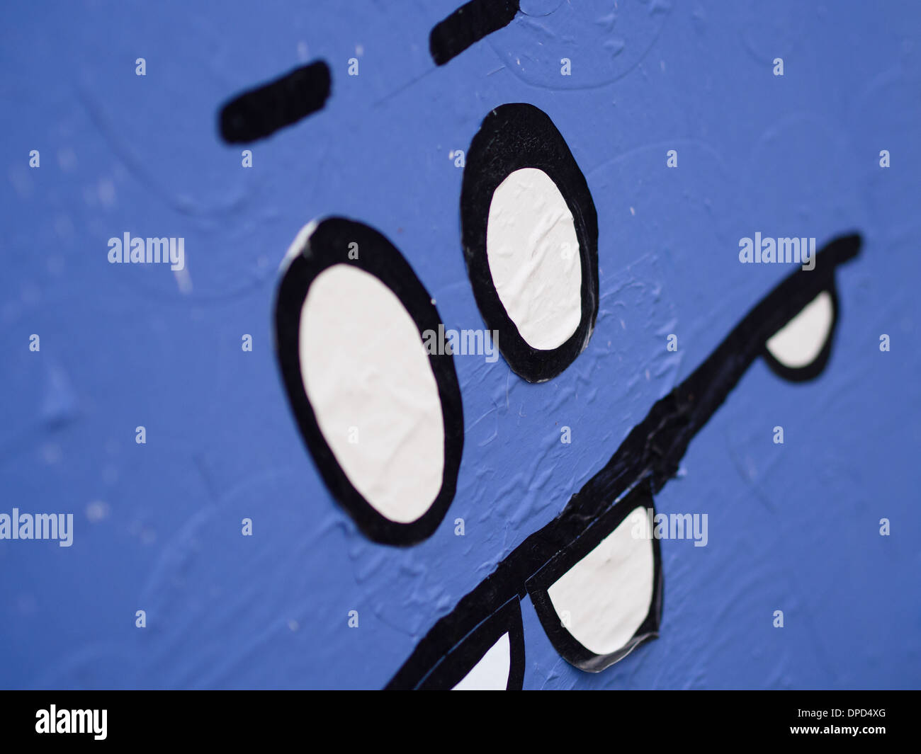 Blue ugly face graffiti Stock Photo - Alamy
