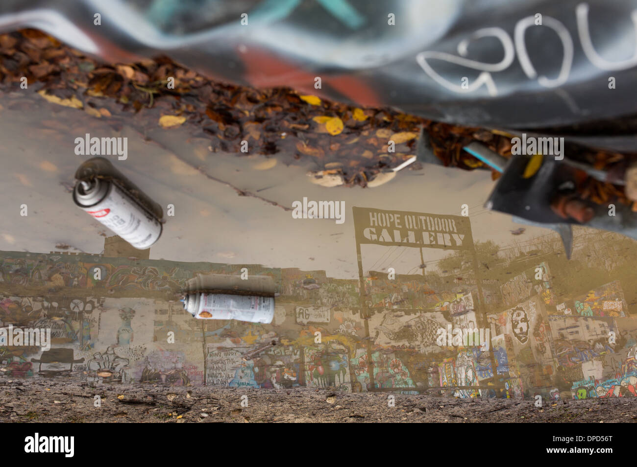 Empty spray cans lay in front of a graffiti wall in the HOPE Outdoor ...