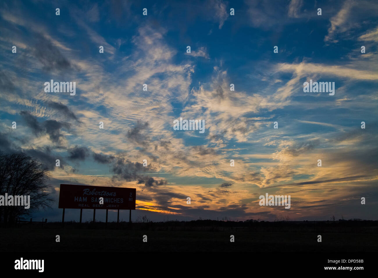 Spectacular sunset behind a billboard, over the plains of Oklahoma ...