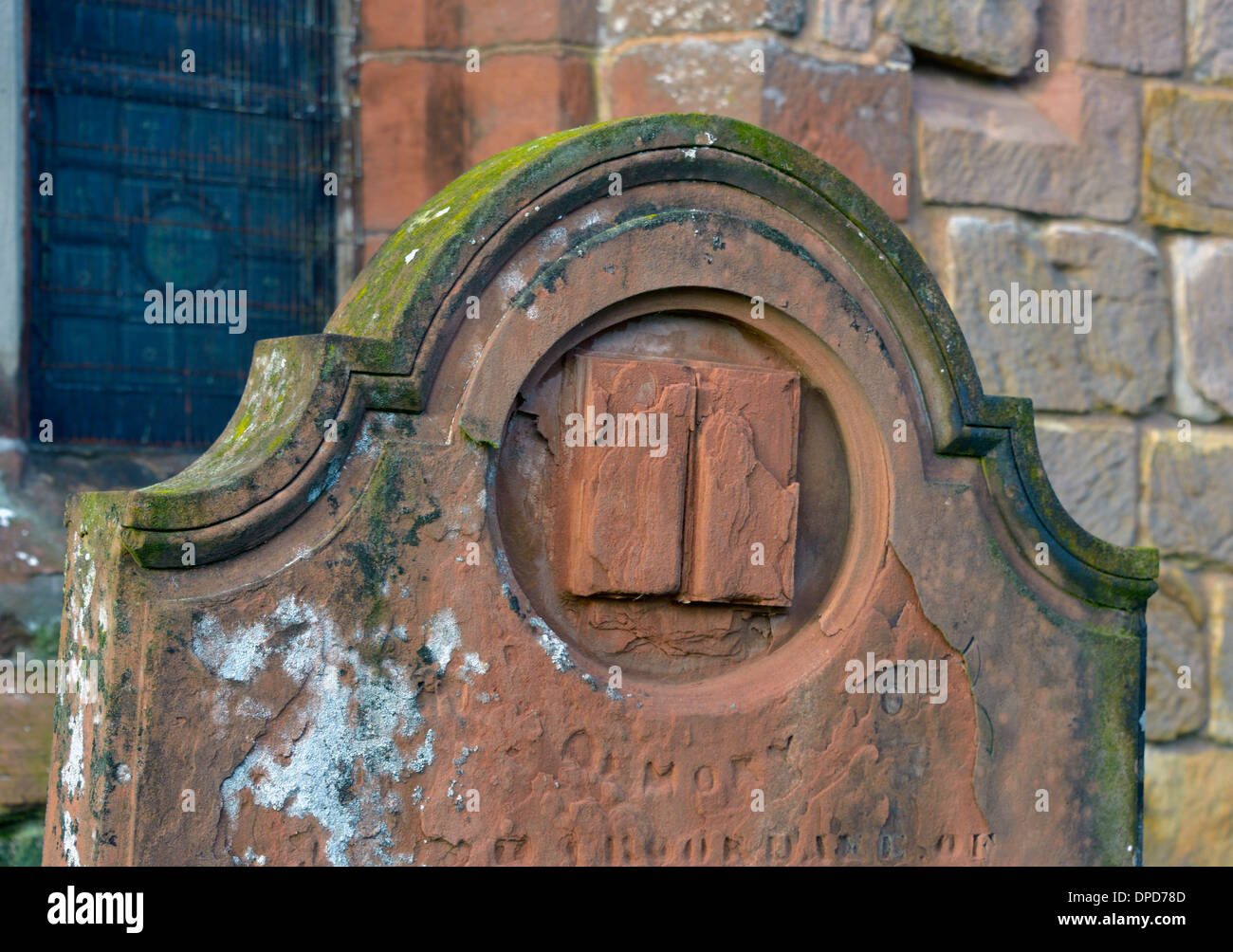 Badly eroded gravestone with book design. Church of Saint Michael ...