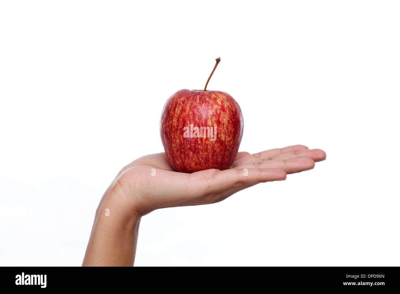 Hand holding red apple against white background Stock Photo - Alamy