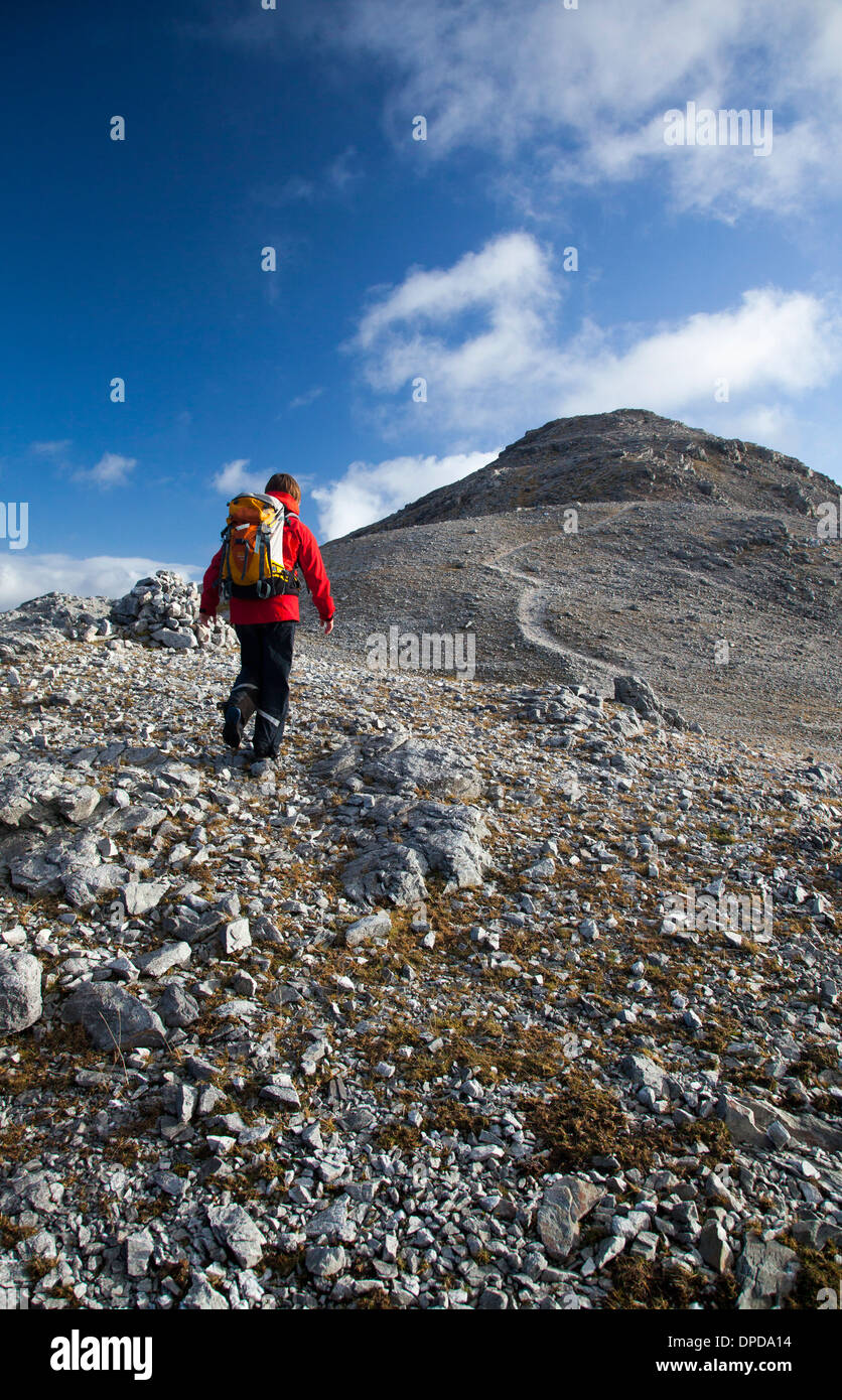 Walker on the northwest shoulder of Benbaun,Twelve Bens, Connemara ...