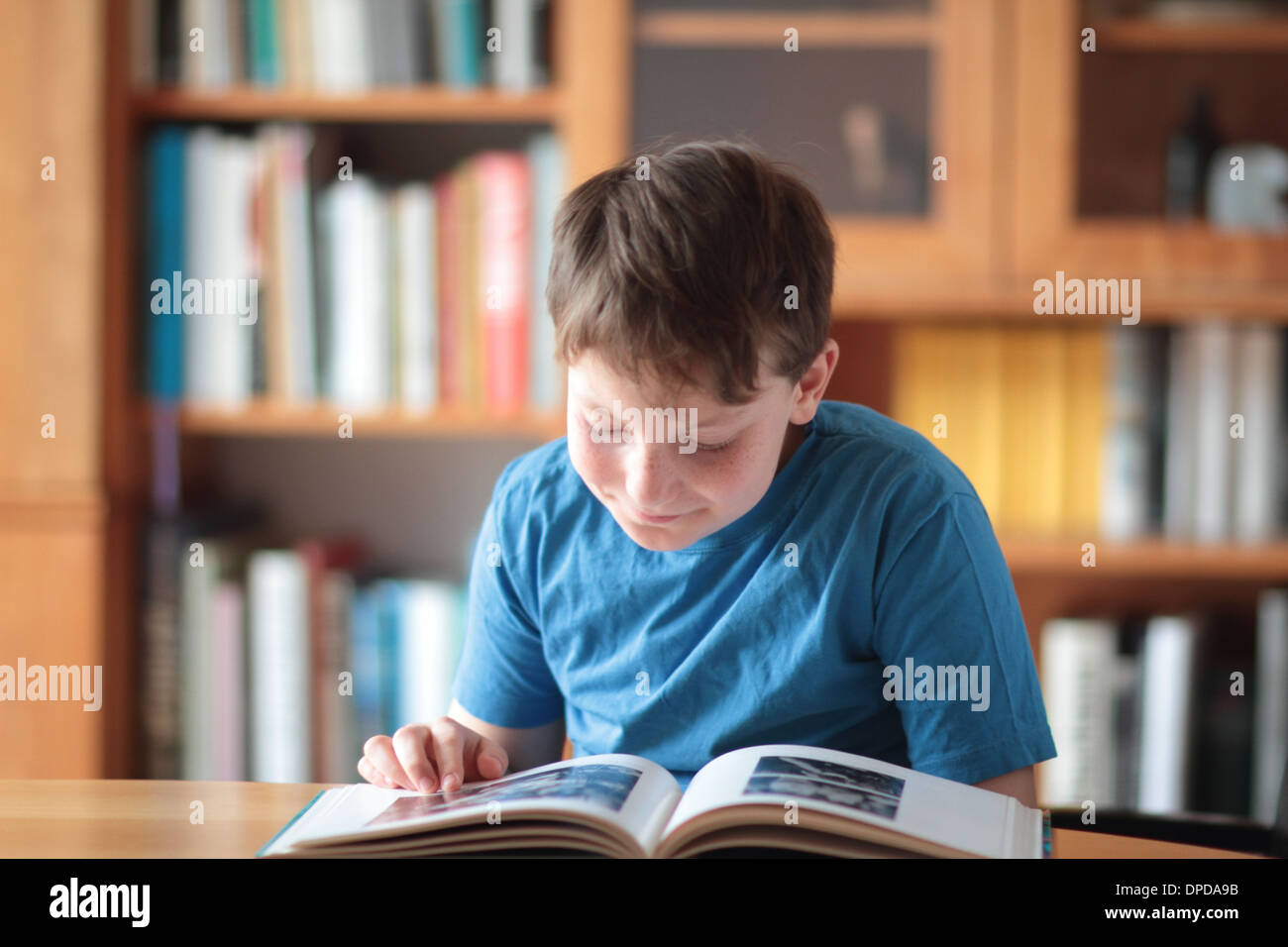 boy looking in a book Stock Photo - Alamy