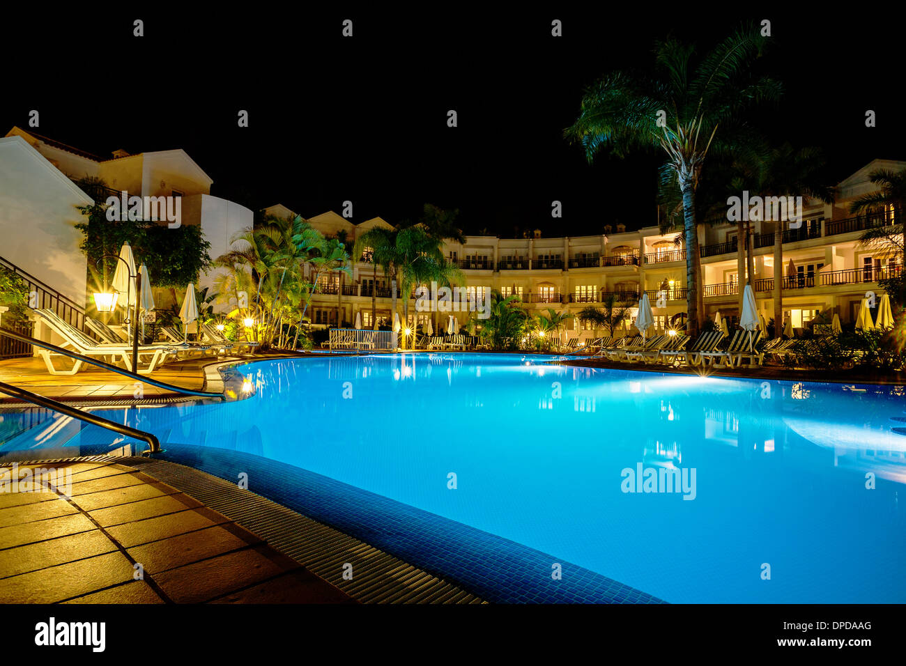 Hotel with pool at night Stock Photo - Alamy