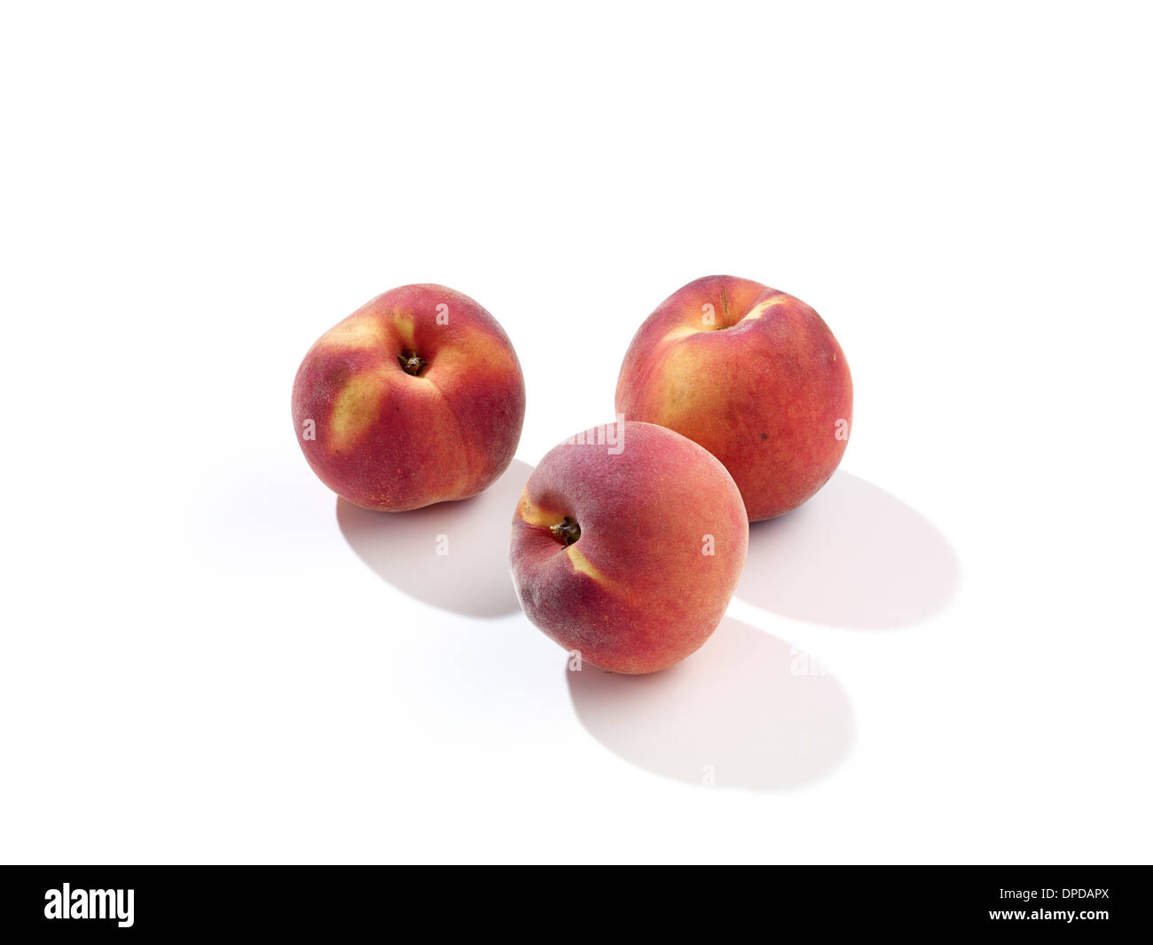 Three peaches, studio shot Stock Photo - Alamy