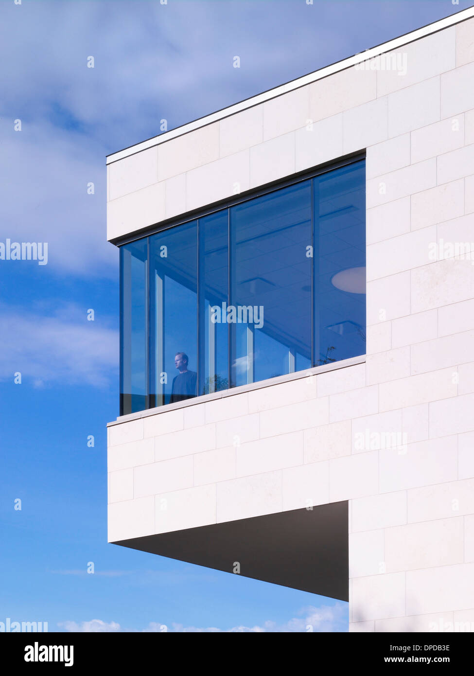 Man standing at window in Administration building, Brandeis University ...