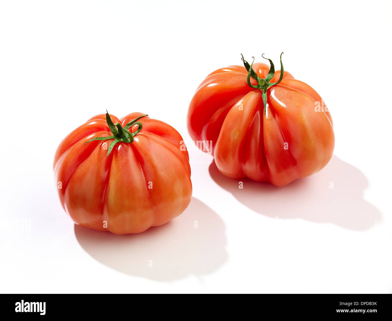 Two beef tomatoes, studio shot Stock Photo - Alamy