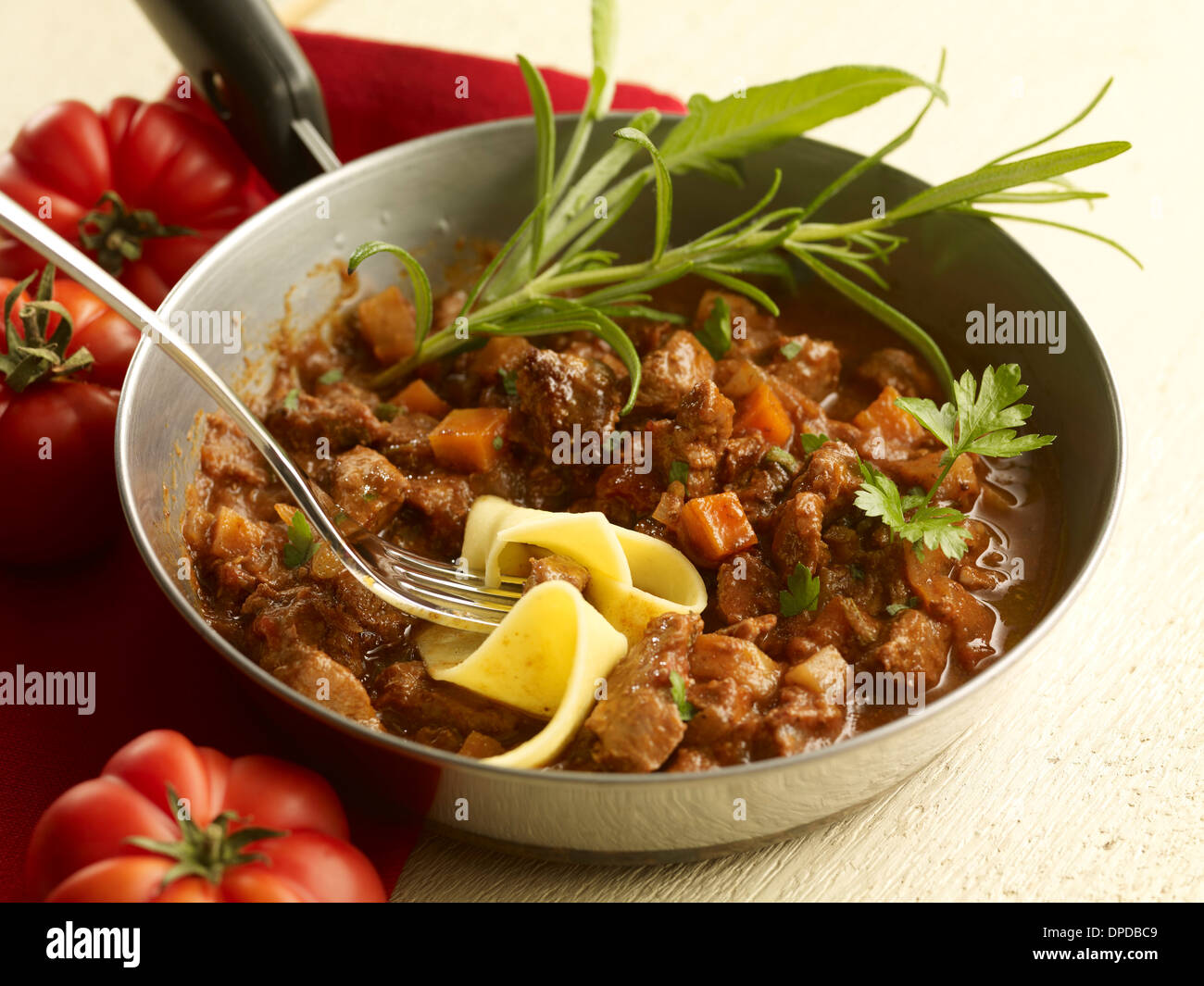 Wild boar stew with pappardelle in pan Stock Photo - Alamy