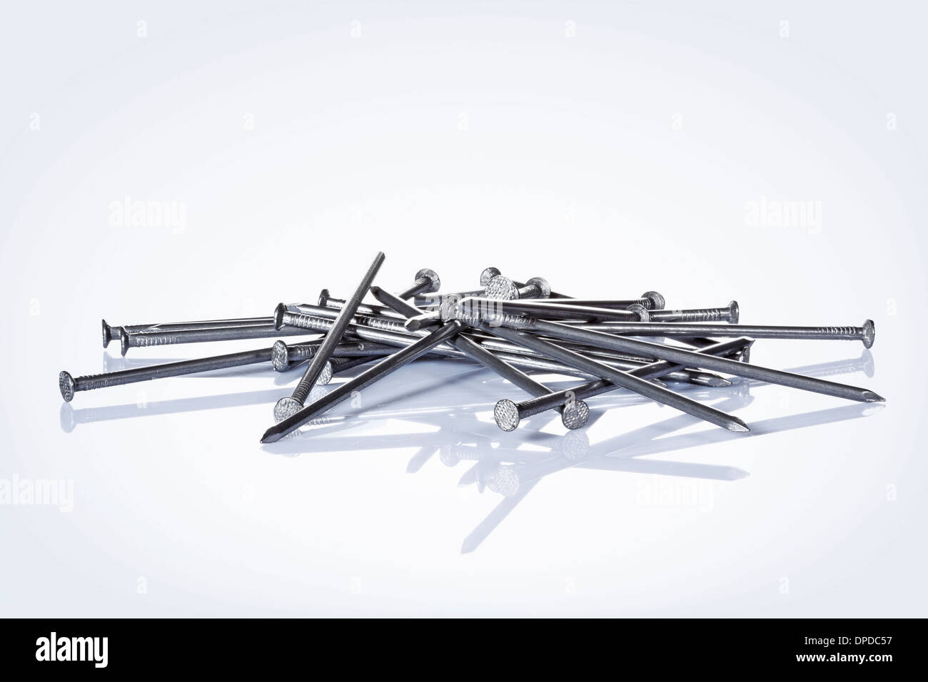 Steel nails on white Stock Photo - Alamy
