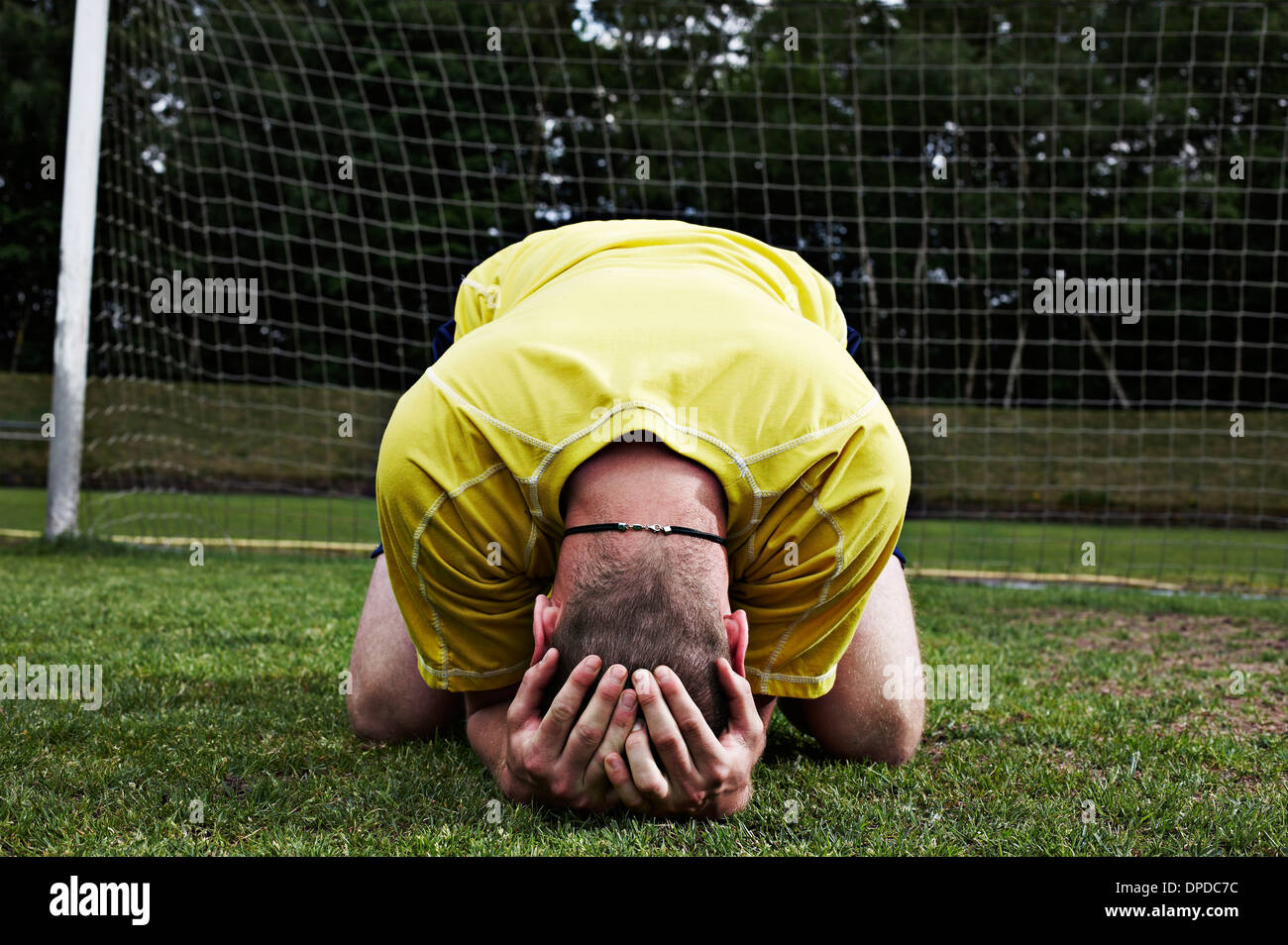 Frustrated soccer player on field Stock Photo - Alamy