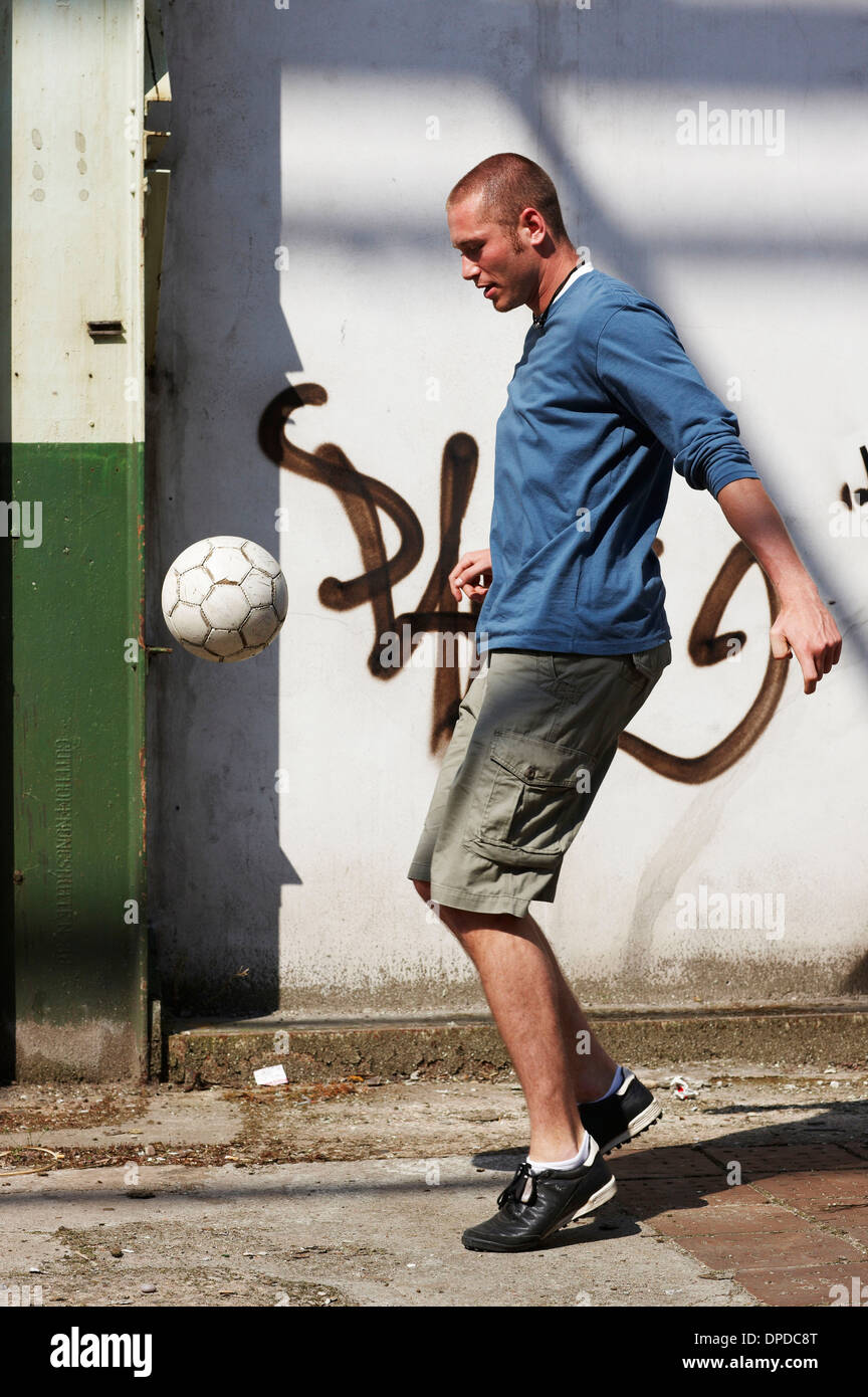 Man playing street soccer Stock Photo - Alamy