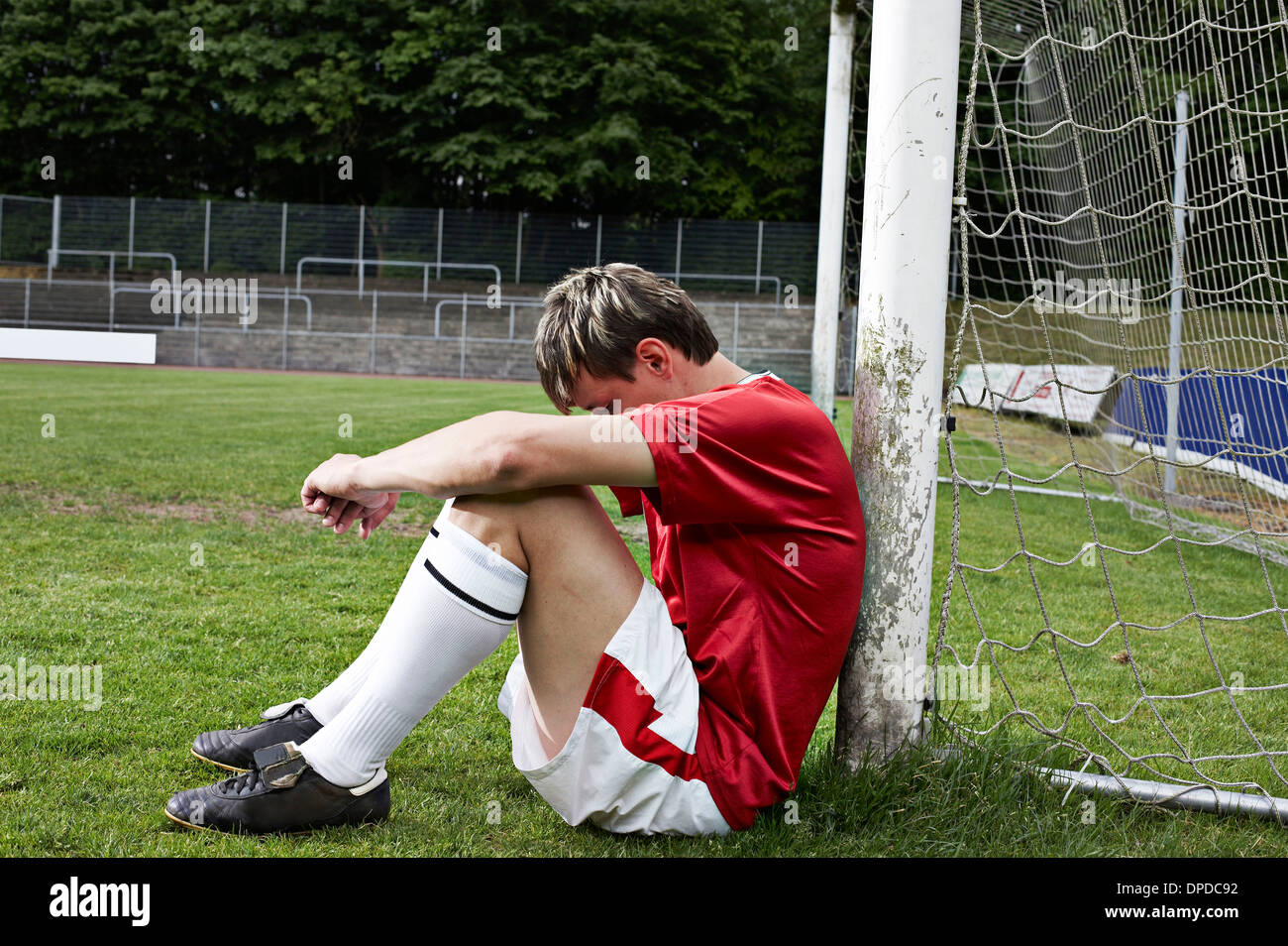 Frustrated soccer player on field Stock Photo - Alamy