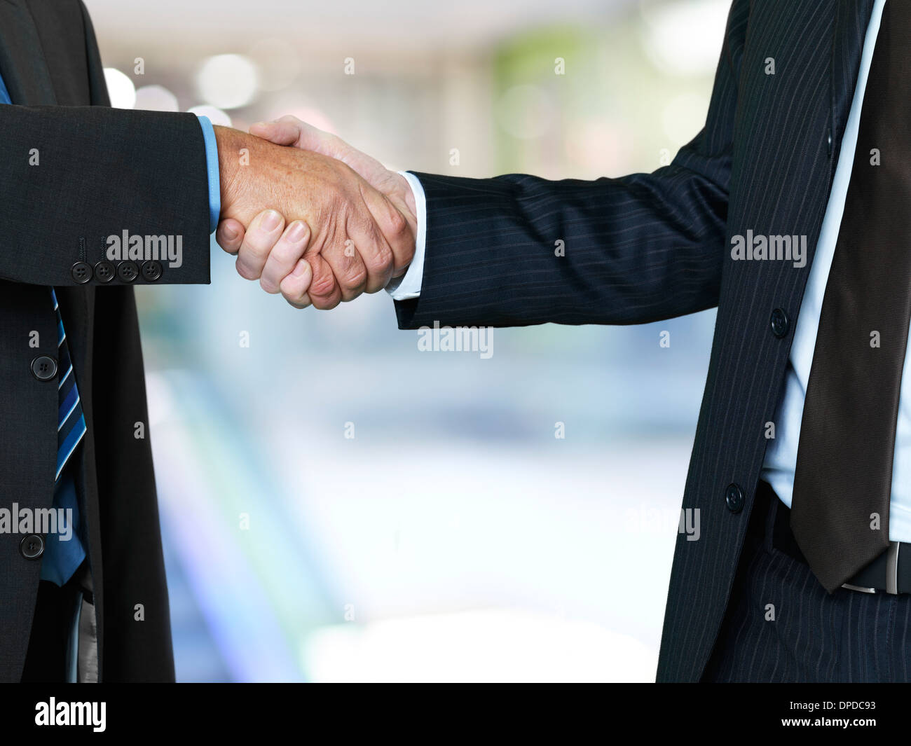 Two businessmen shaking hands Stock Photo - Alamy