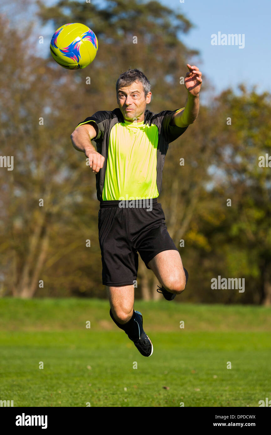 Soccer player with ball on field Stock Photo - Alamy