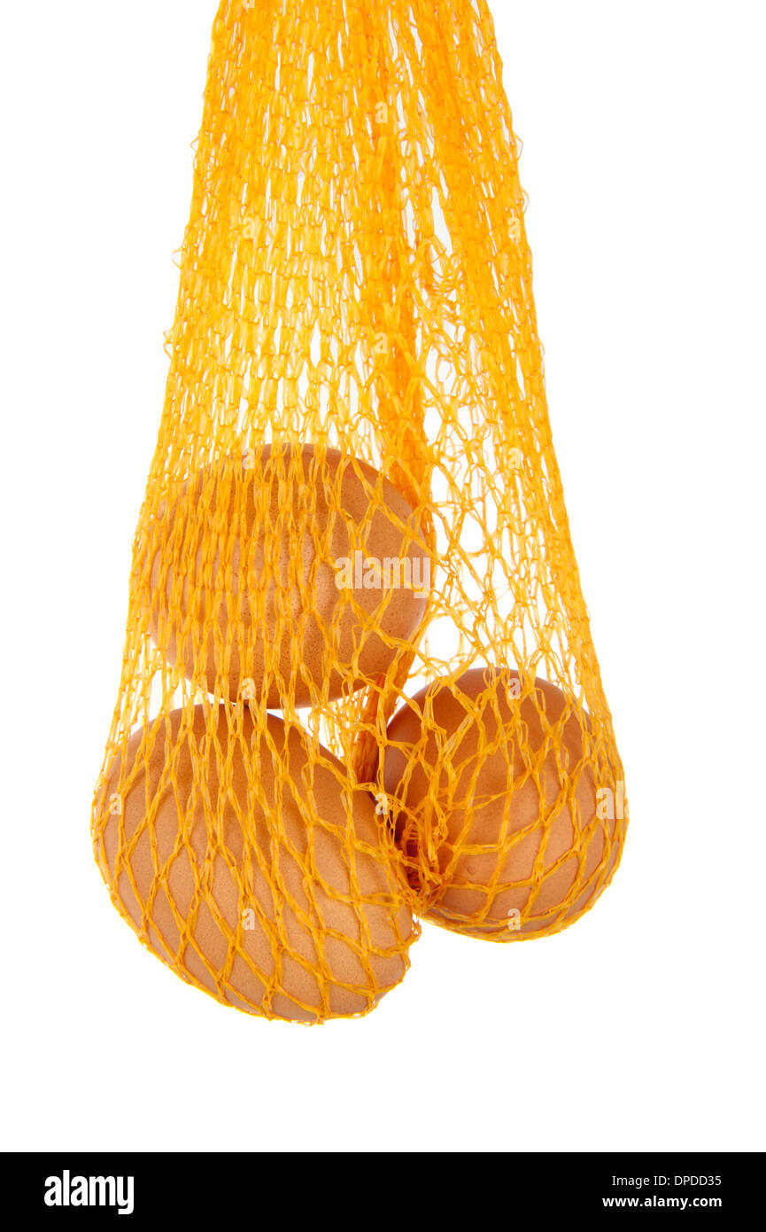 three eggs hanging in yellow net isolated in white Stock Photo - Alamy