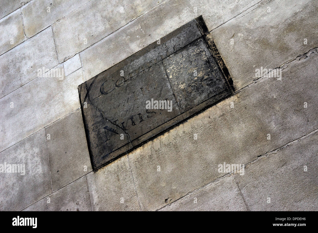Old London street sign "Commit no Nuisance" on a stone walled building ...