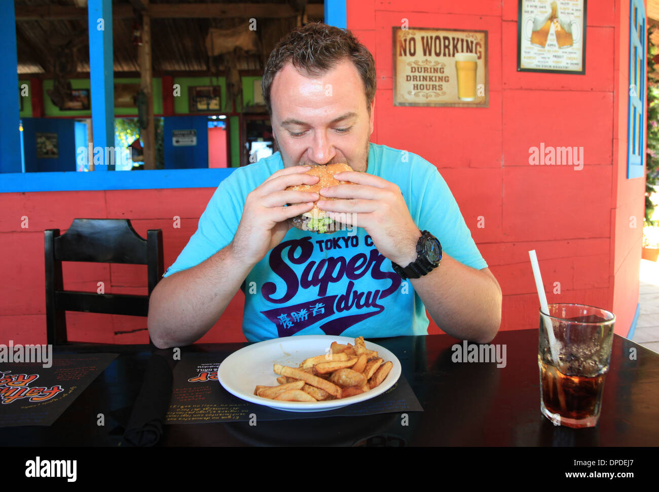 Fat person eating chips hi-res stock photography and images - Alamy