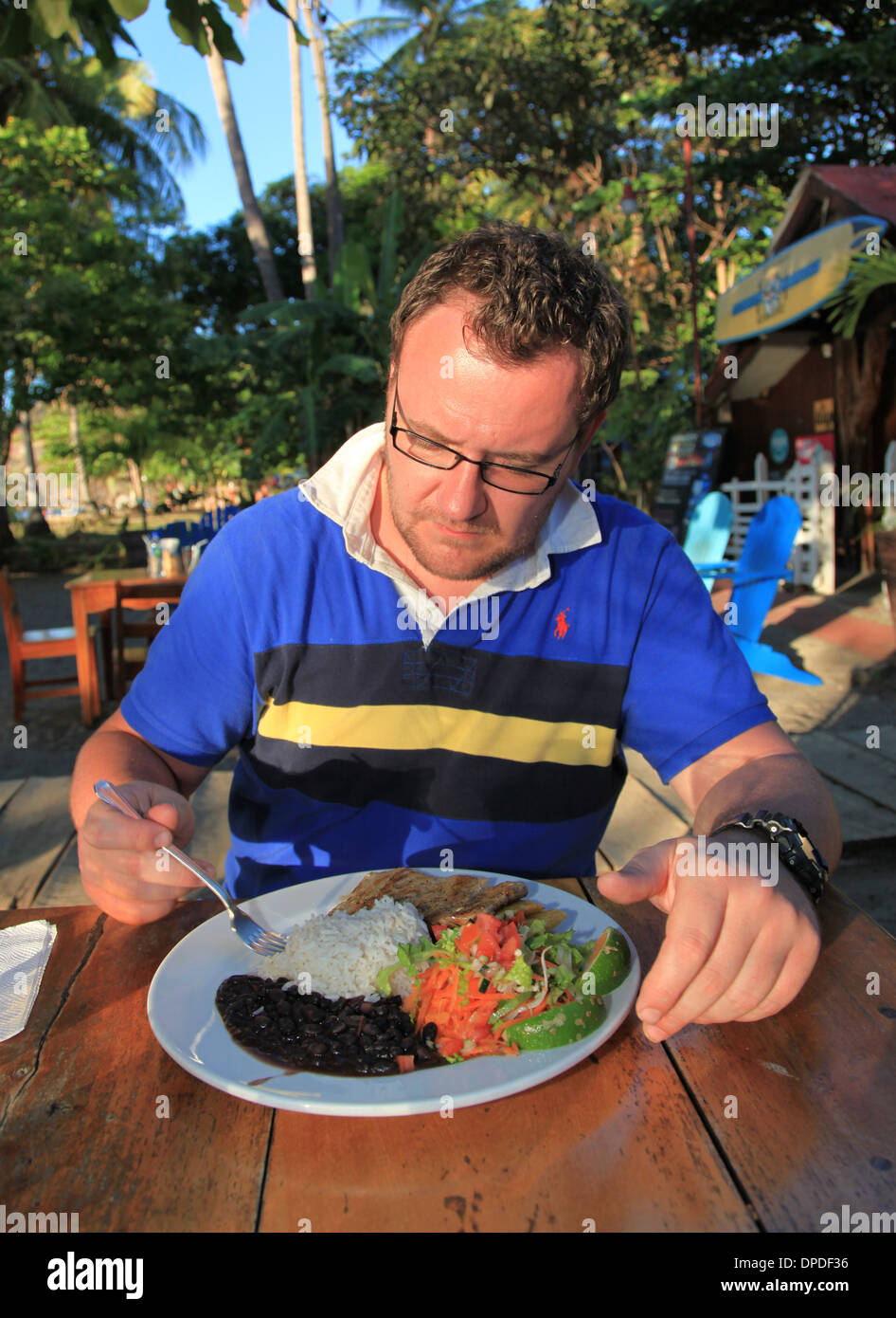 Young man eating food Stock Photo - Alamy