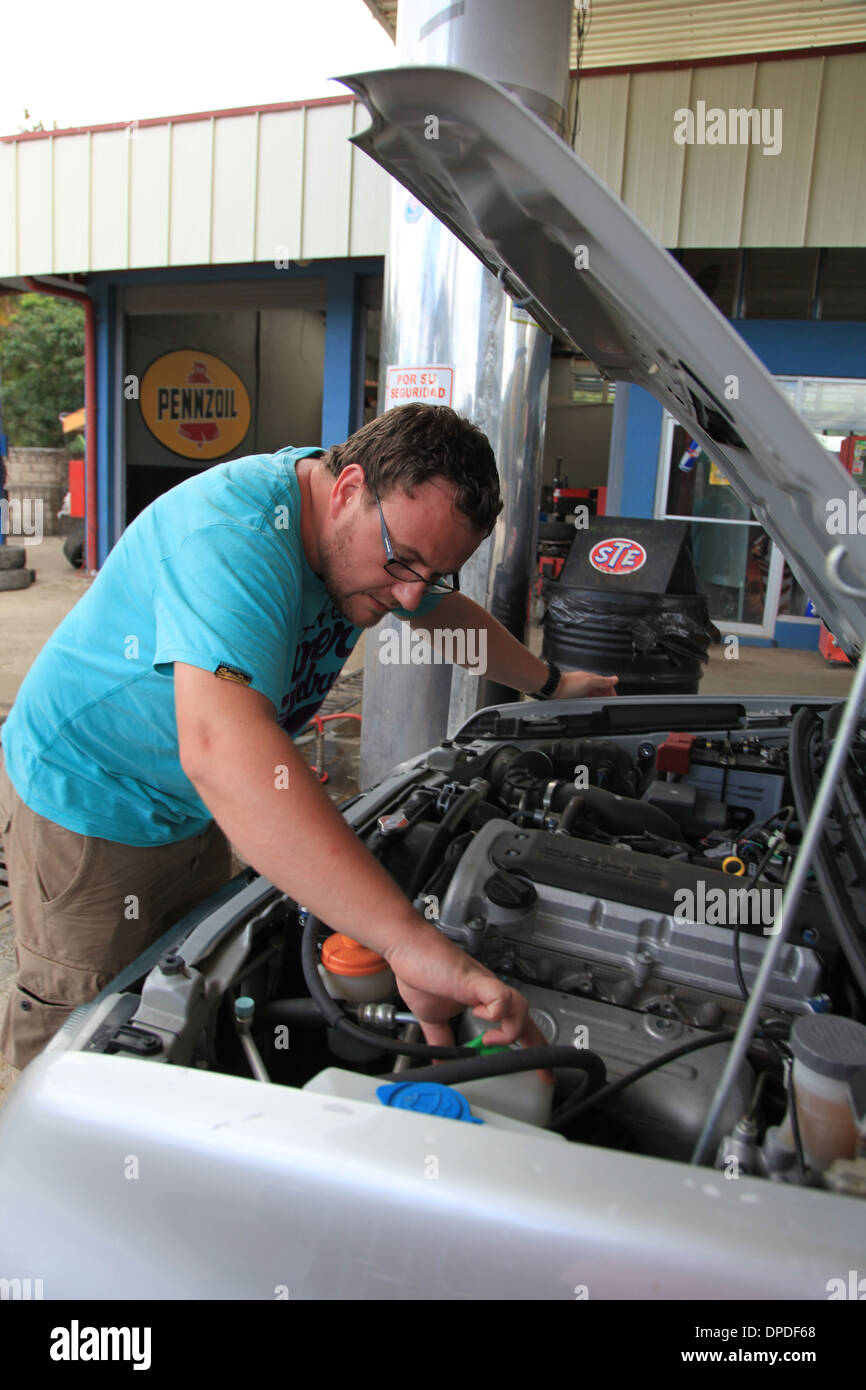 Man checking under the bonnet of a car Stock Photo - Alamy
