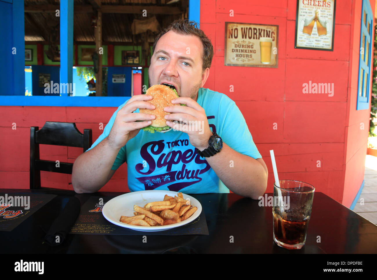 Fat man eating chips hi-res stock photography and images - Alamy