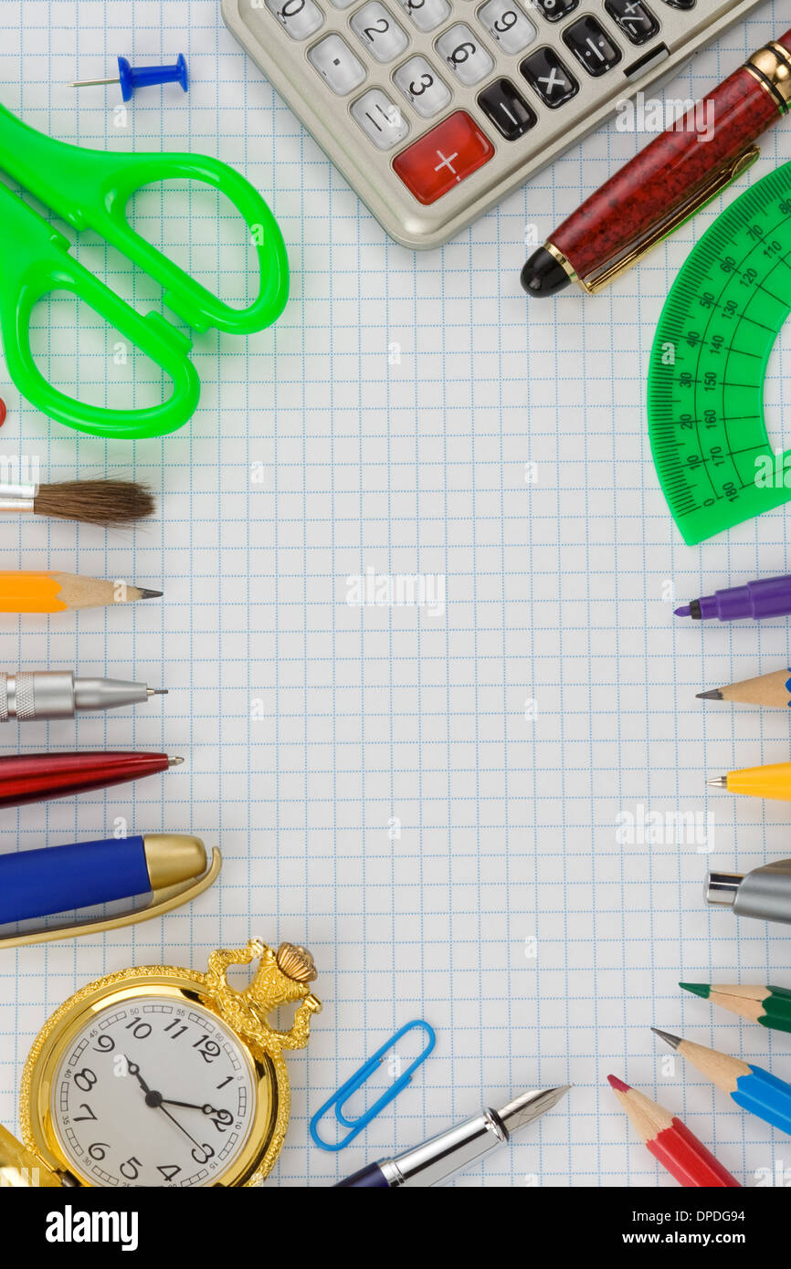 school supplies on checked notebook paper Stock Photo - Alamy