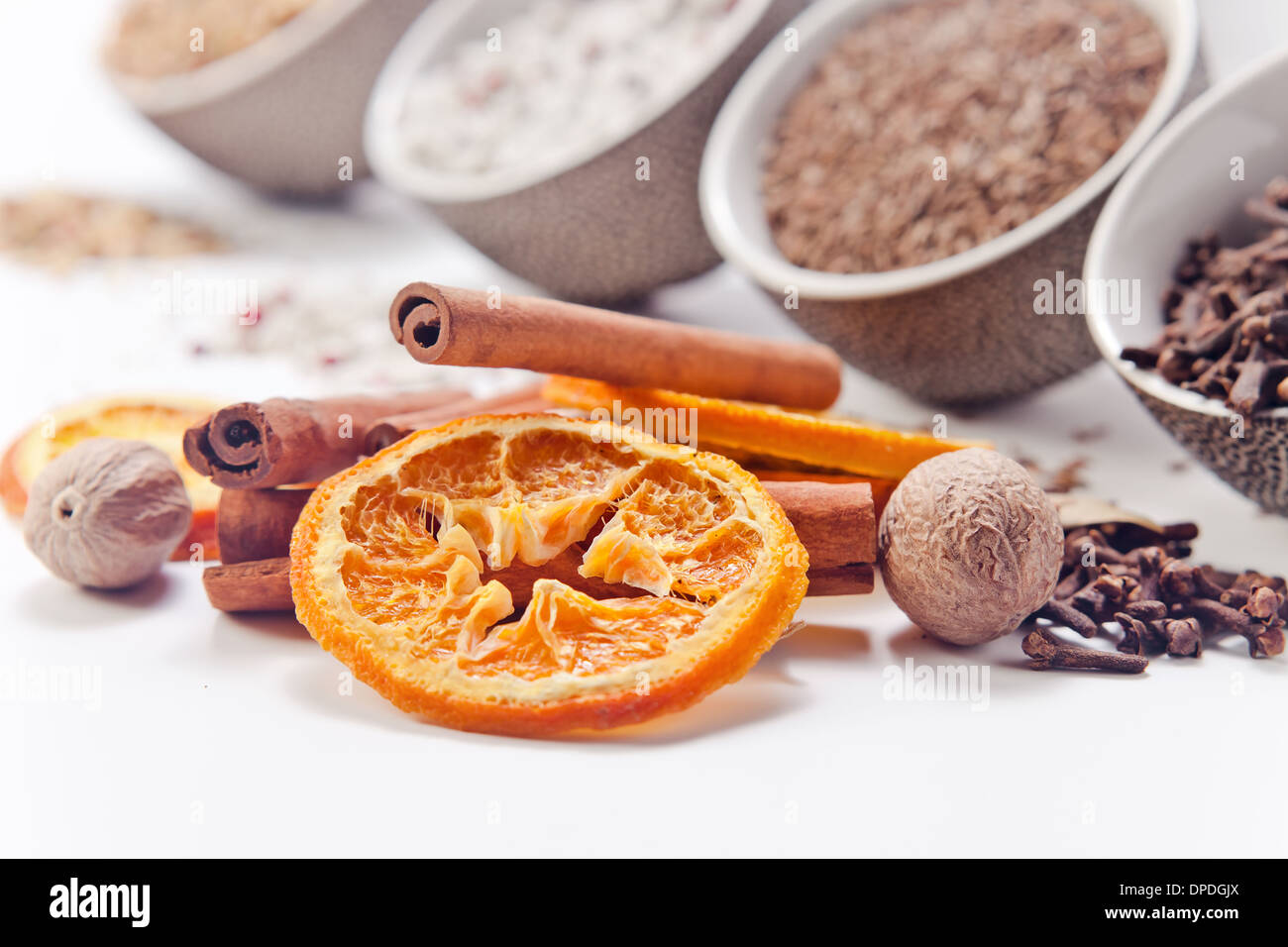 spices with dried oranges on white background Stock Photo - Alamy