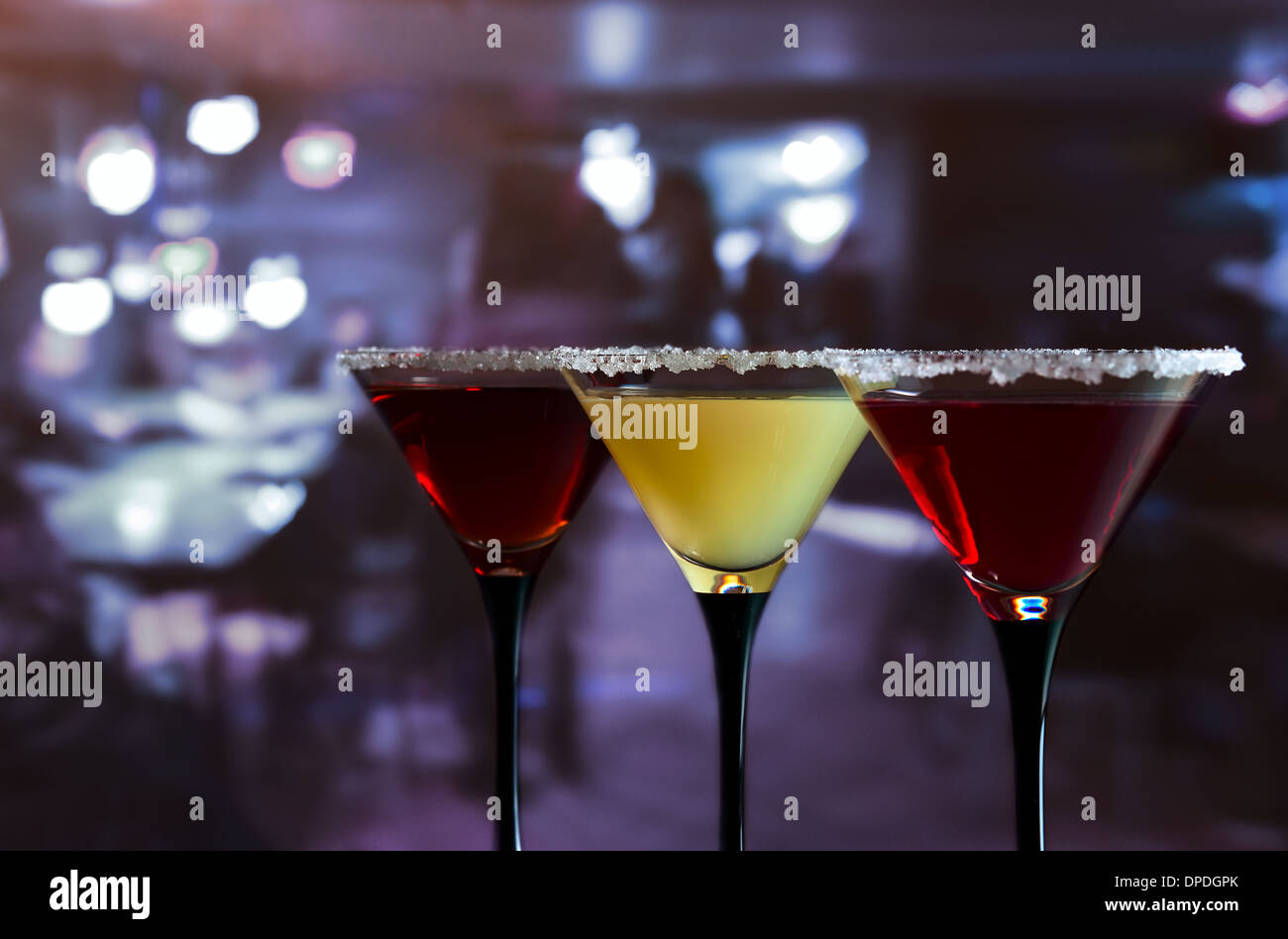 three glasses with cocktail on dark background Stock Photo - Alamy