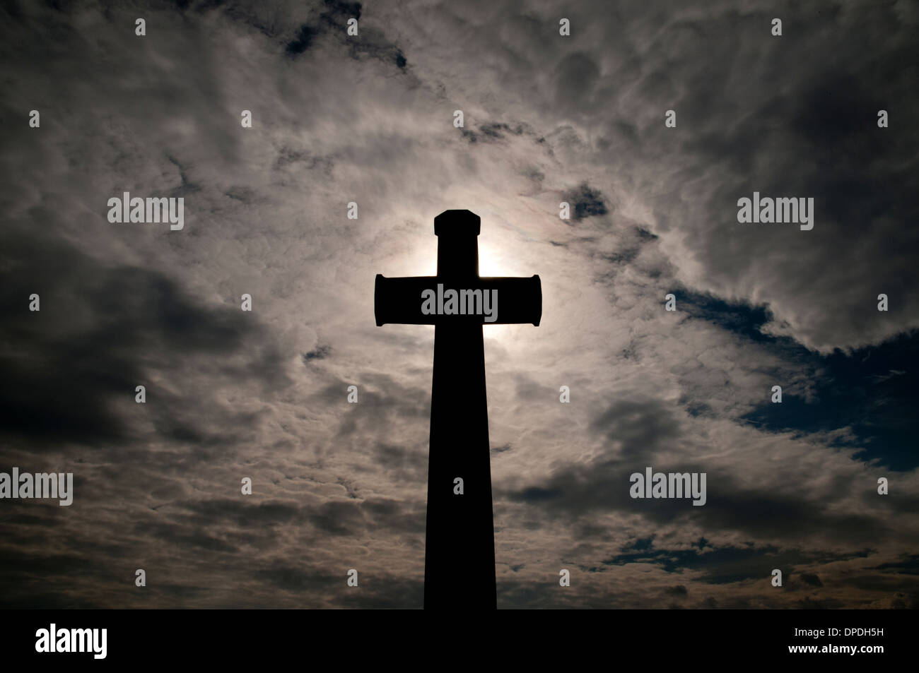 Cross of sacrifice silhouetted against the sky at a Commonwealth War ...