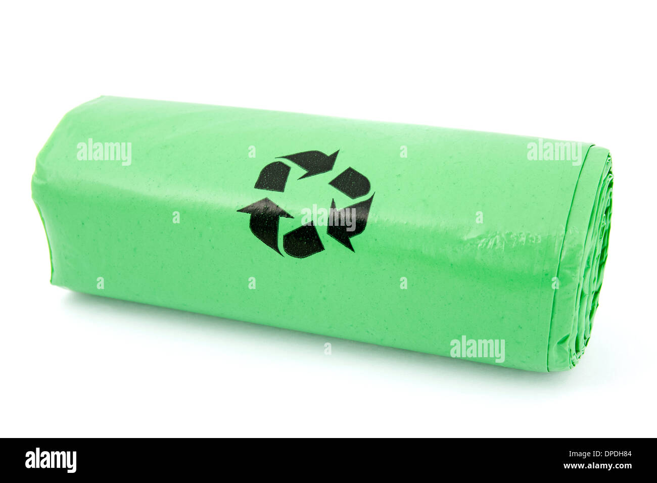 Green garbage bio bags in a roll on white background Stock Photo - Alamy