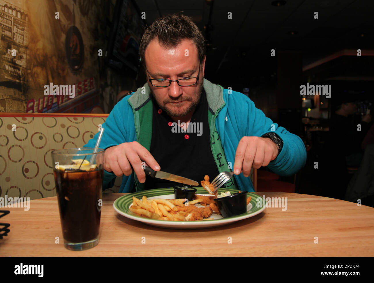 Young man eating food Stock Photo - Alamy