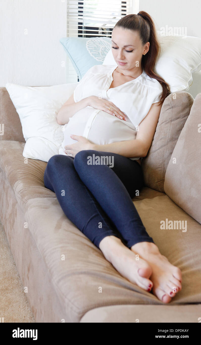 Beautiful young pregnant woman lying hi-res stock photography and ...