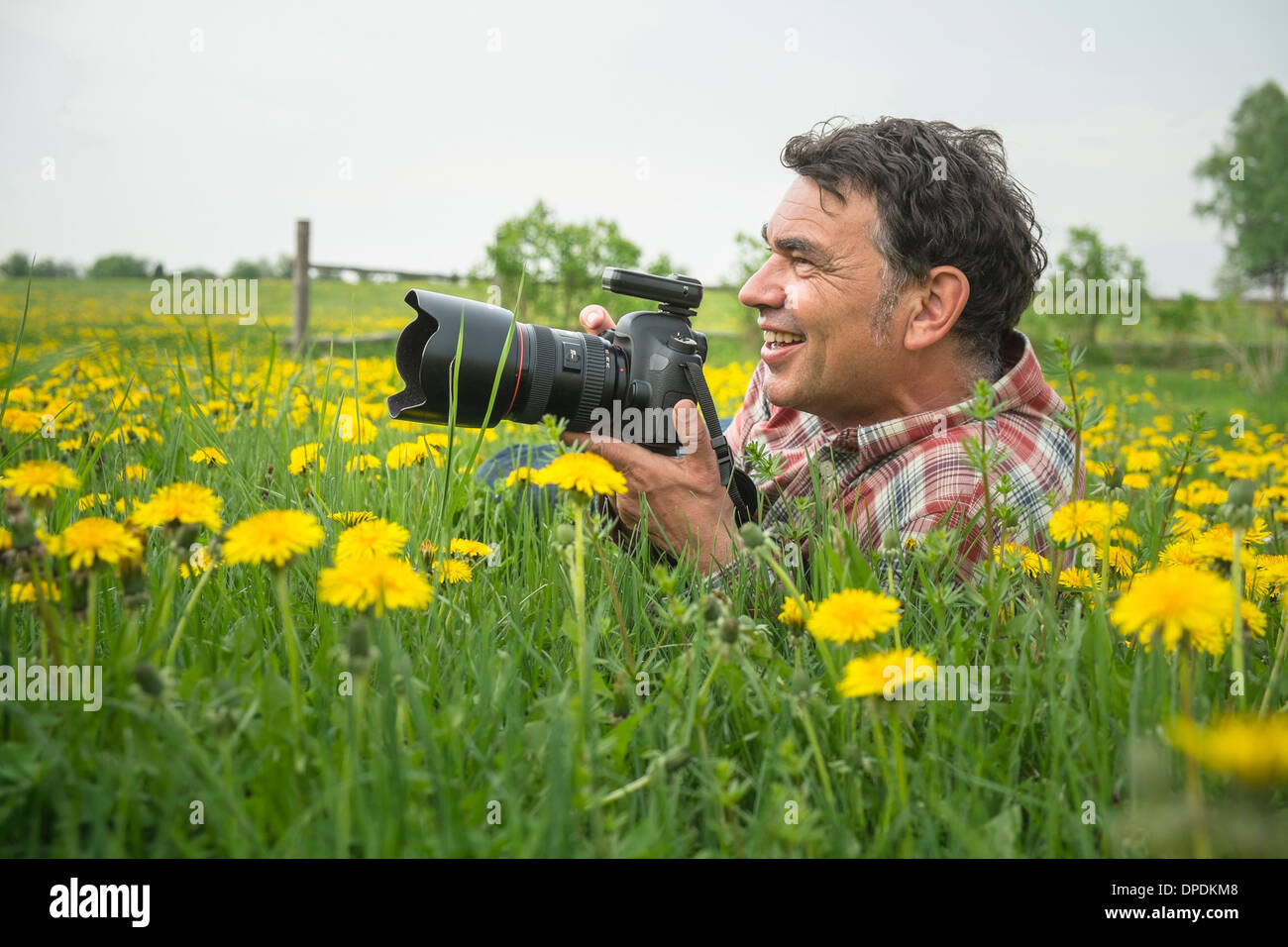 Photographer in field Stock Photo - Alamy
