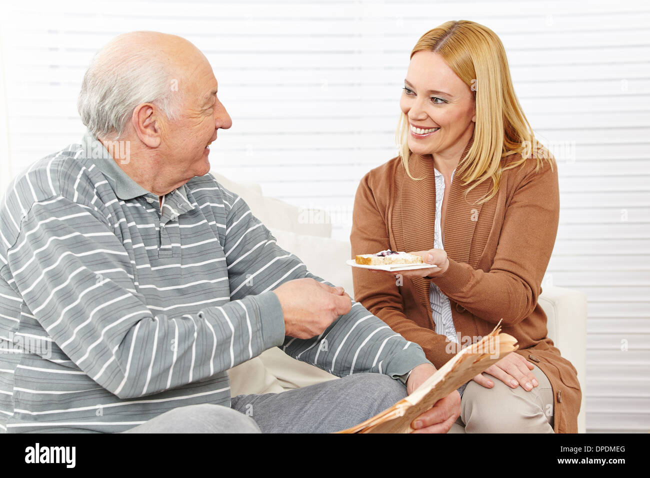 Senior citizen and woman eating breakfast at assisted living home Stock ...