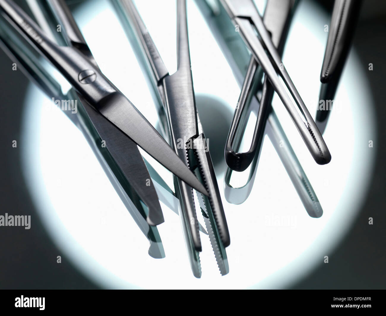 Surgical instruments on sterile tray with reflection of theatre light ...