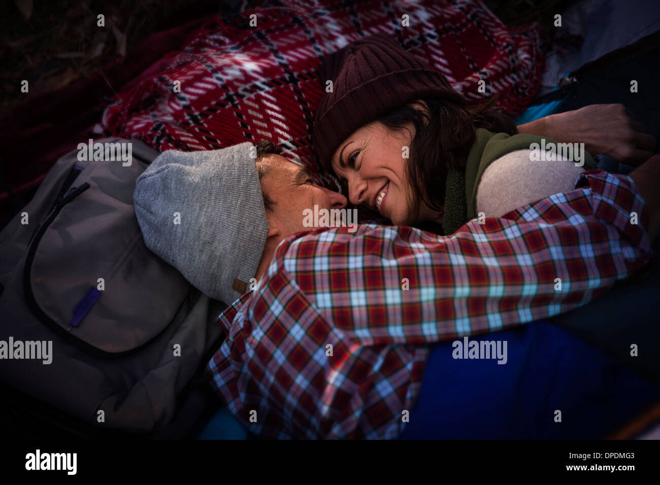 Mature couple lying down, hugging on picnic rug Stock Photo - Alamy