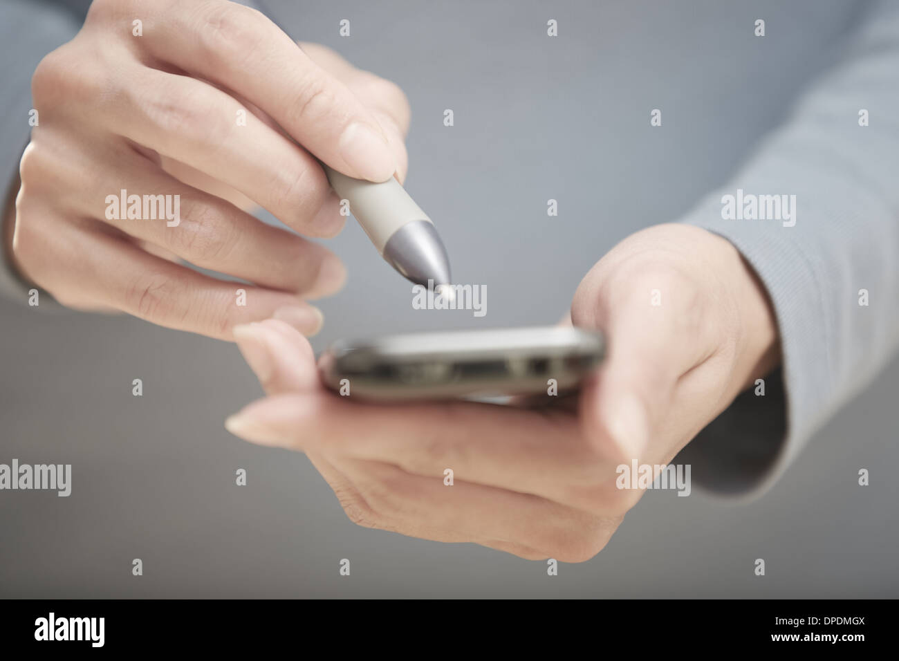 Human hands using smartphone and stylus Stock Photo - Alamy