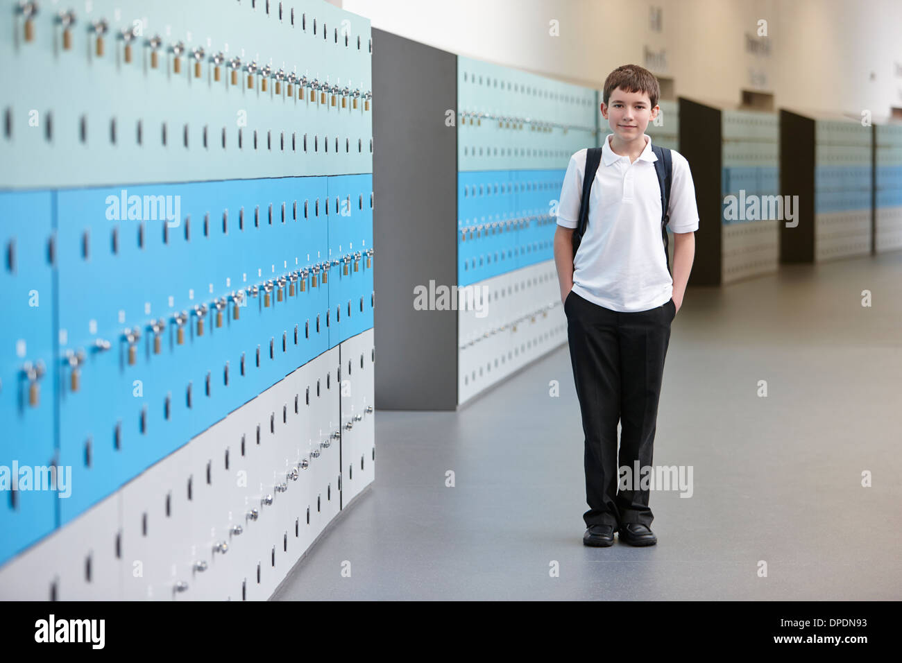 Portrait of schoolboy with hands in pockets in school corridor Stock ...