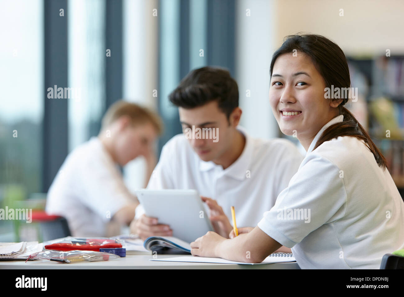 Teenagers working in school classroom Stock Photo - Alamy
