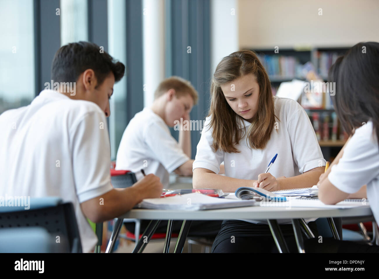 Group of teenagers working in school class Stock Photo - Alamy