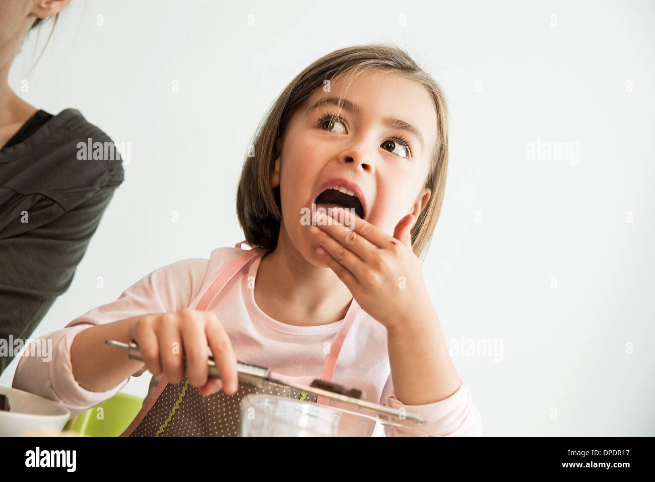 Young woman licking finger hi-res stock photography and images - Alamy