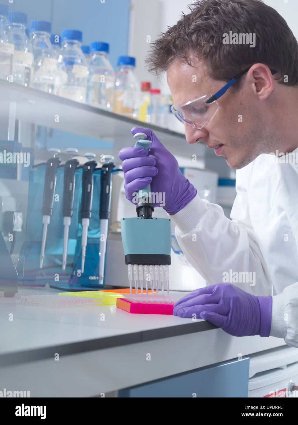 Male researcher holding pipette hi-res stock photography and images - Alamy