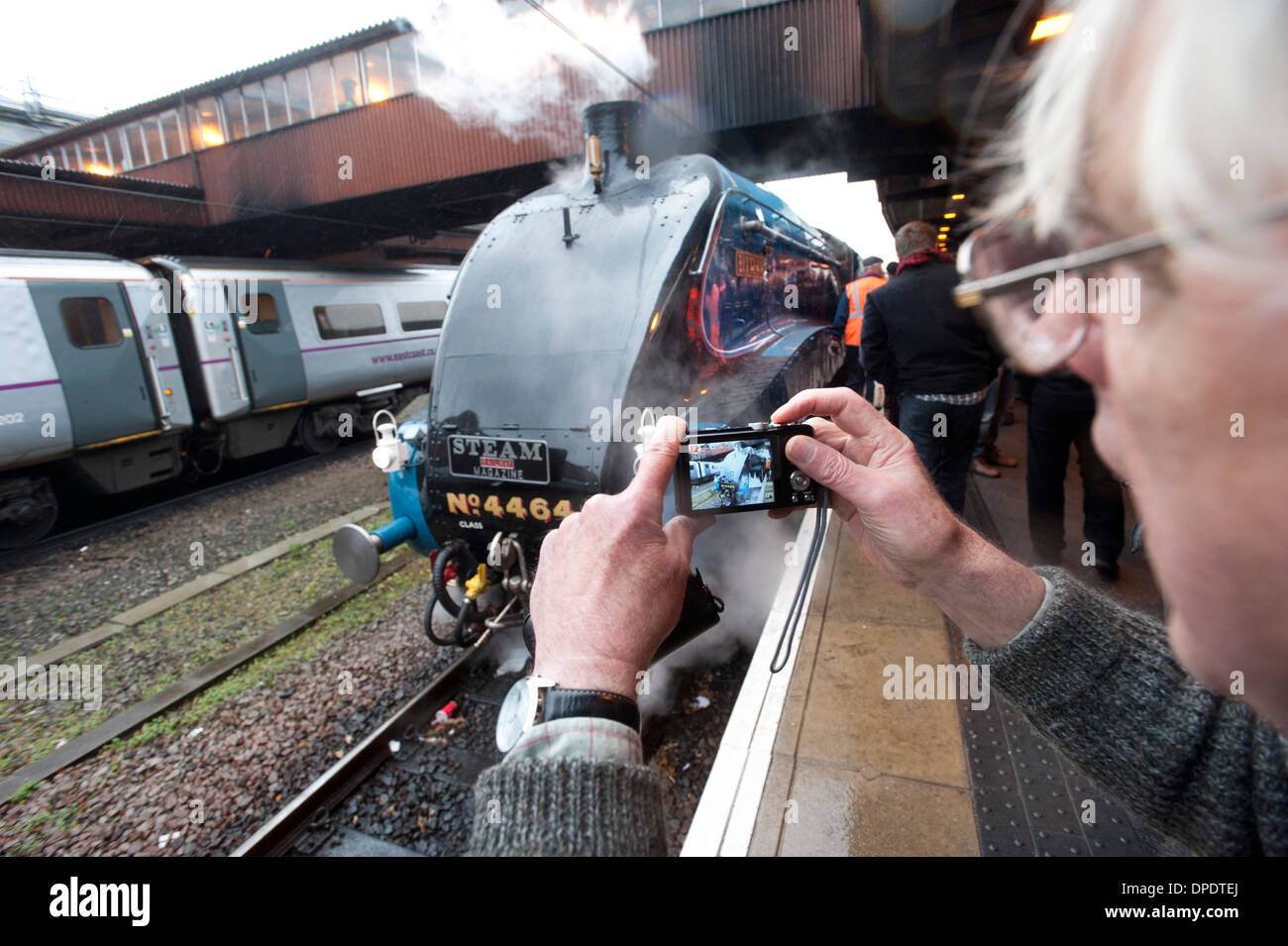 An amateur photographer with a small digital camera taking a picture of ...