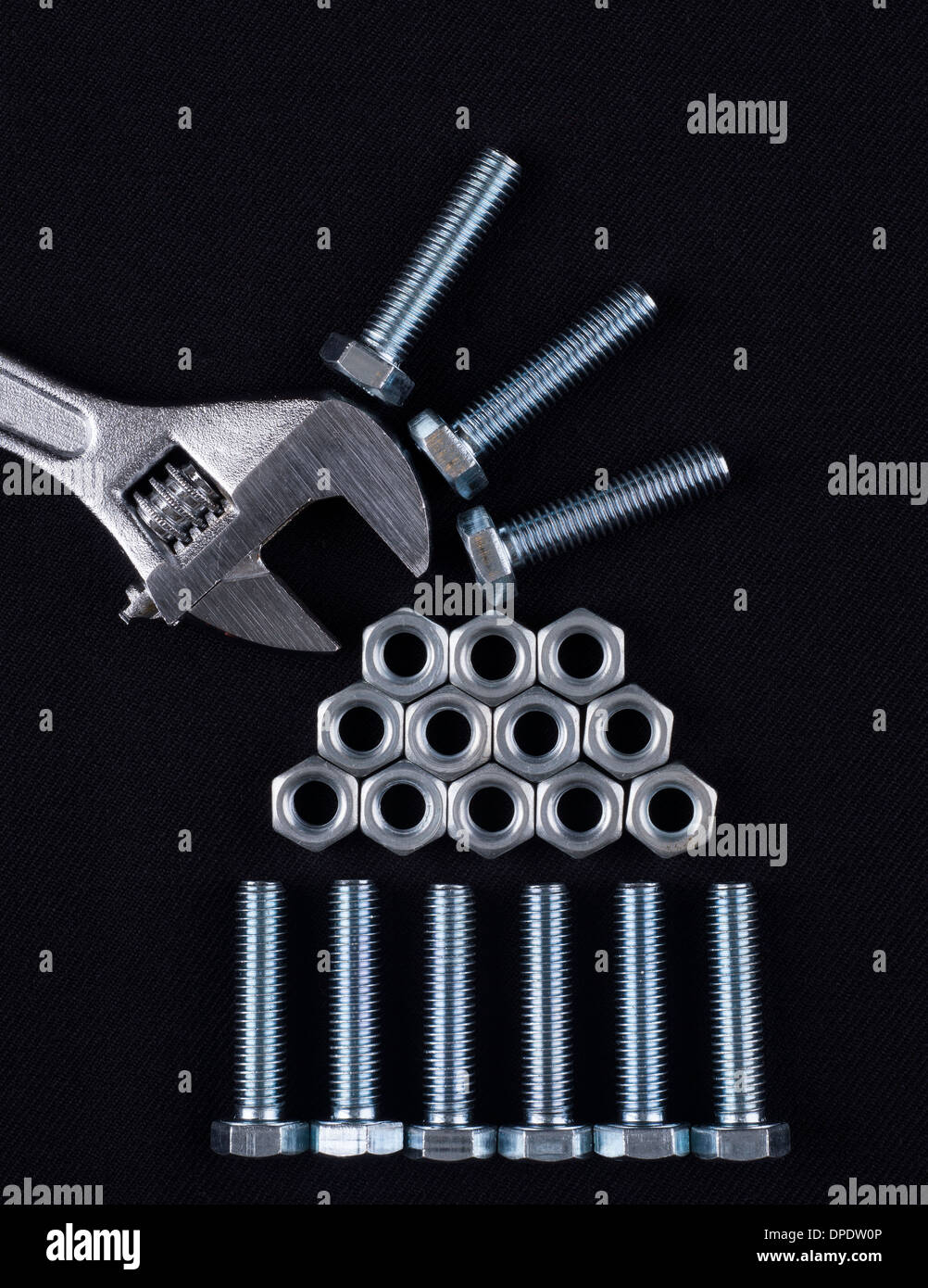 Adjustable wrench with screws and nuts on black background Stock Photo ...