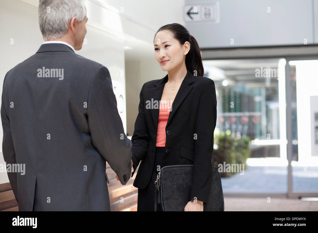 Shaking hands asian woman hi-res stock photography and images - Alamy