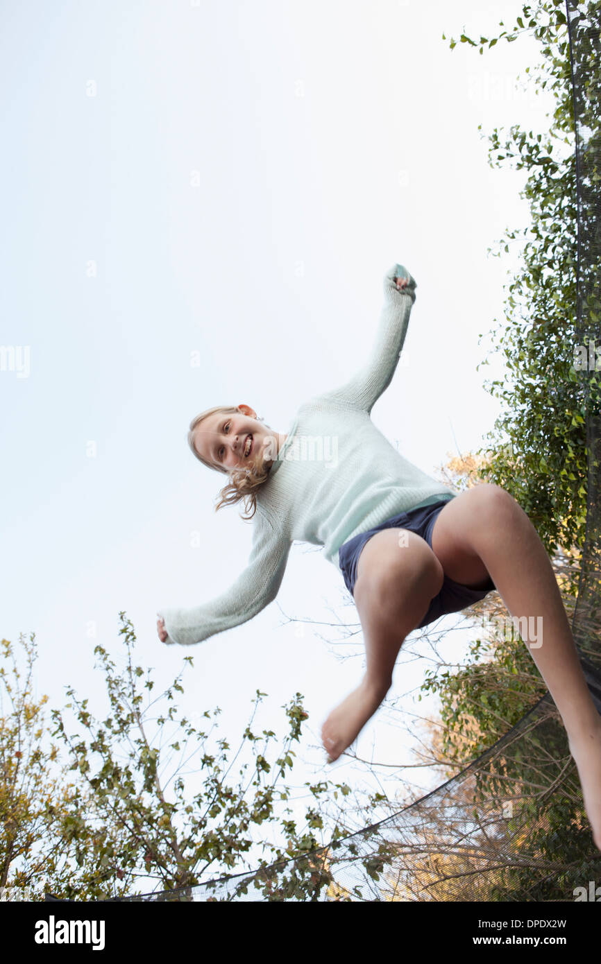 Girl jumping mid air on garden trampoline Stock Photo - Alamy